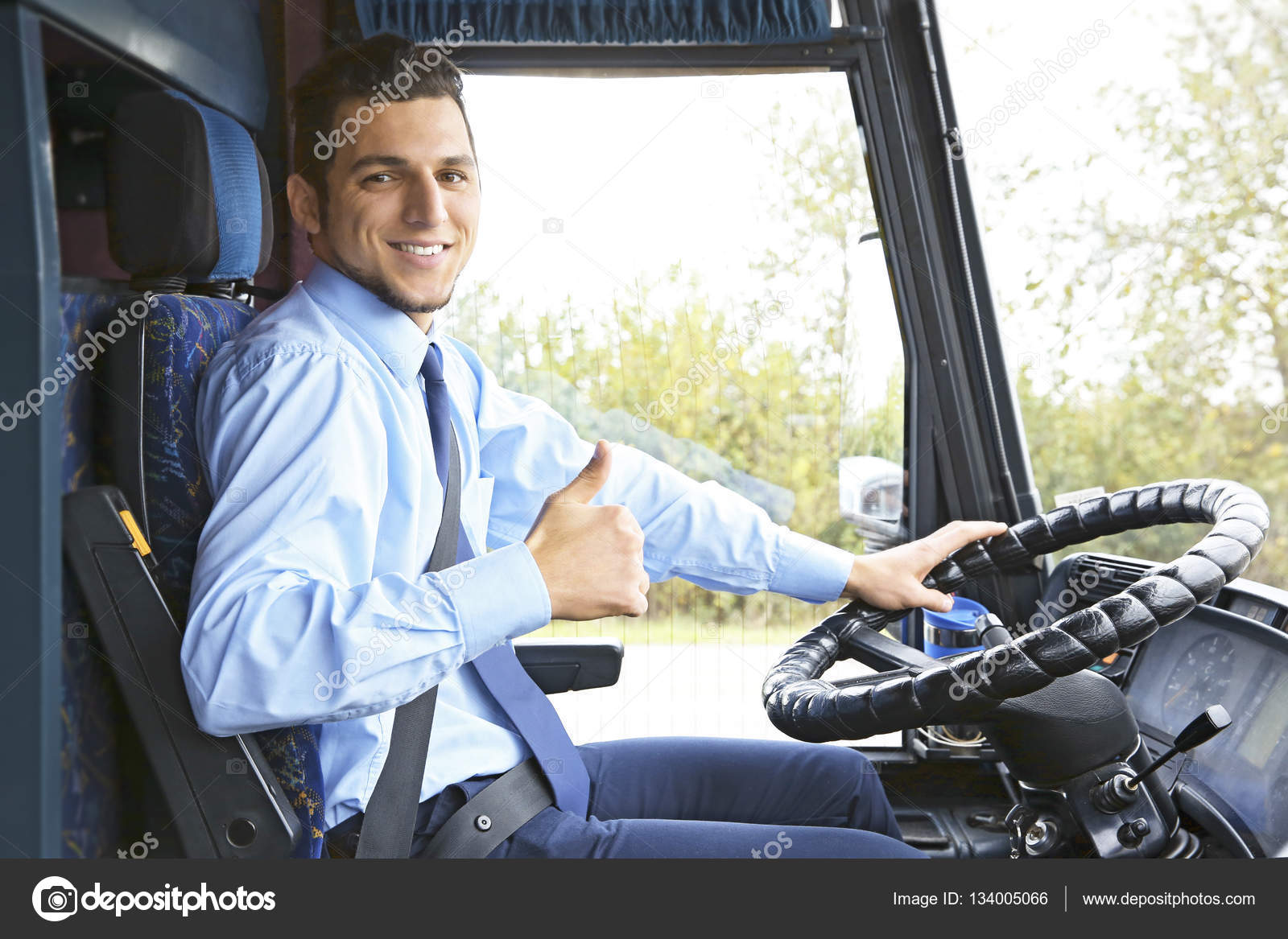 Handsome driver in bus Stock Photo by ©belchonock 134005066