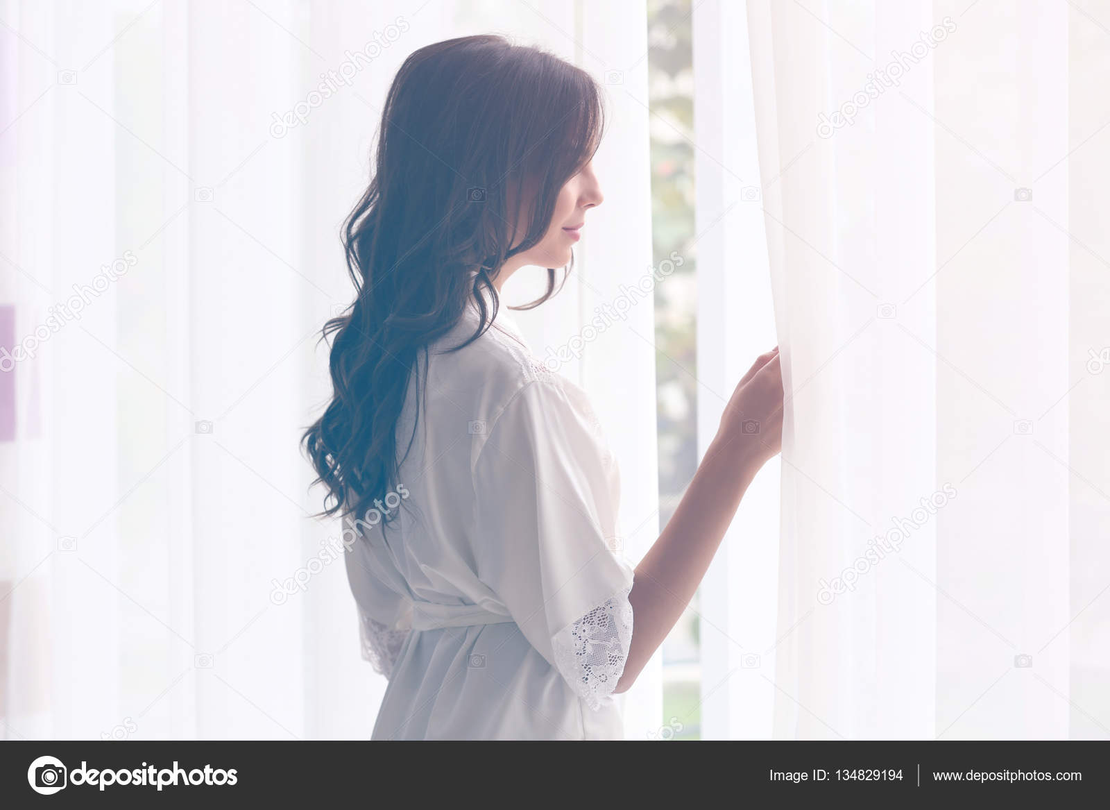 Beautiful woman in white silk robe — Stock Photo © belchonock #134829194