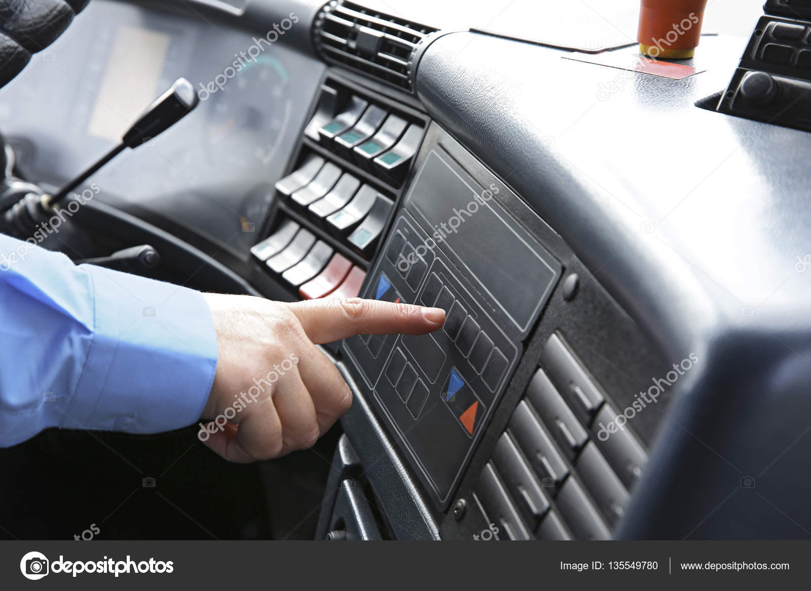 Bus driver pushing button Stock Photo by ©belchonock 135549780