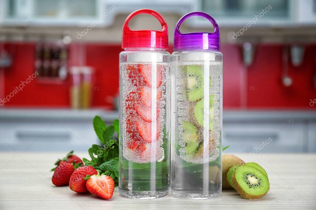 Bottles with fruit-infused water — Stock Photo © belchonock #135550058