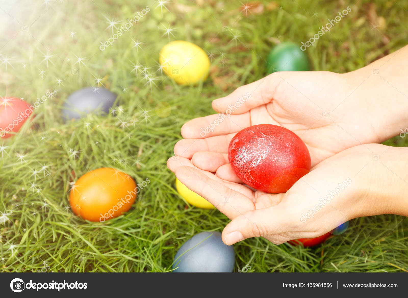 Female hands holding Easter egg Stock Photo by ©belchonock 135981856