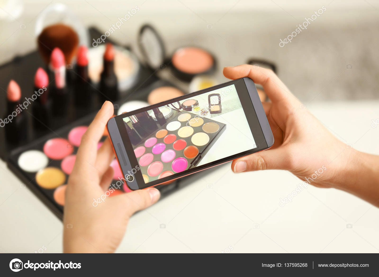 Makeup kit on mobile phone display — Stock Photo © belchonock #137595268