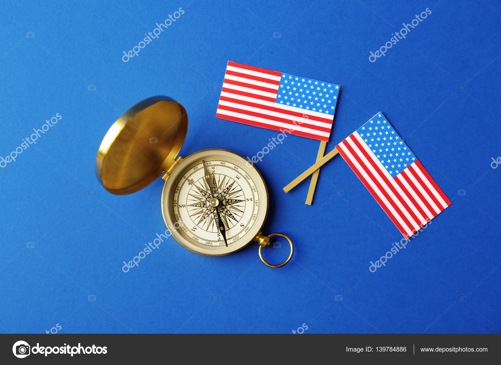 Two USA flags and compass Stock Photo by ©belchonock 139784886