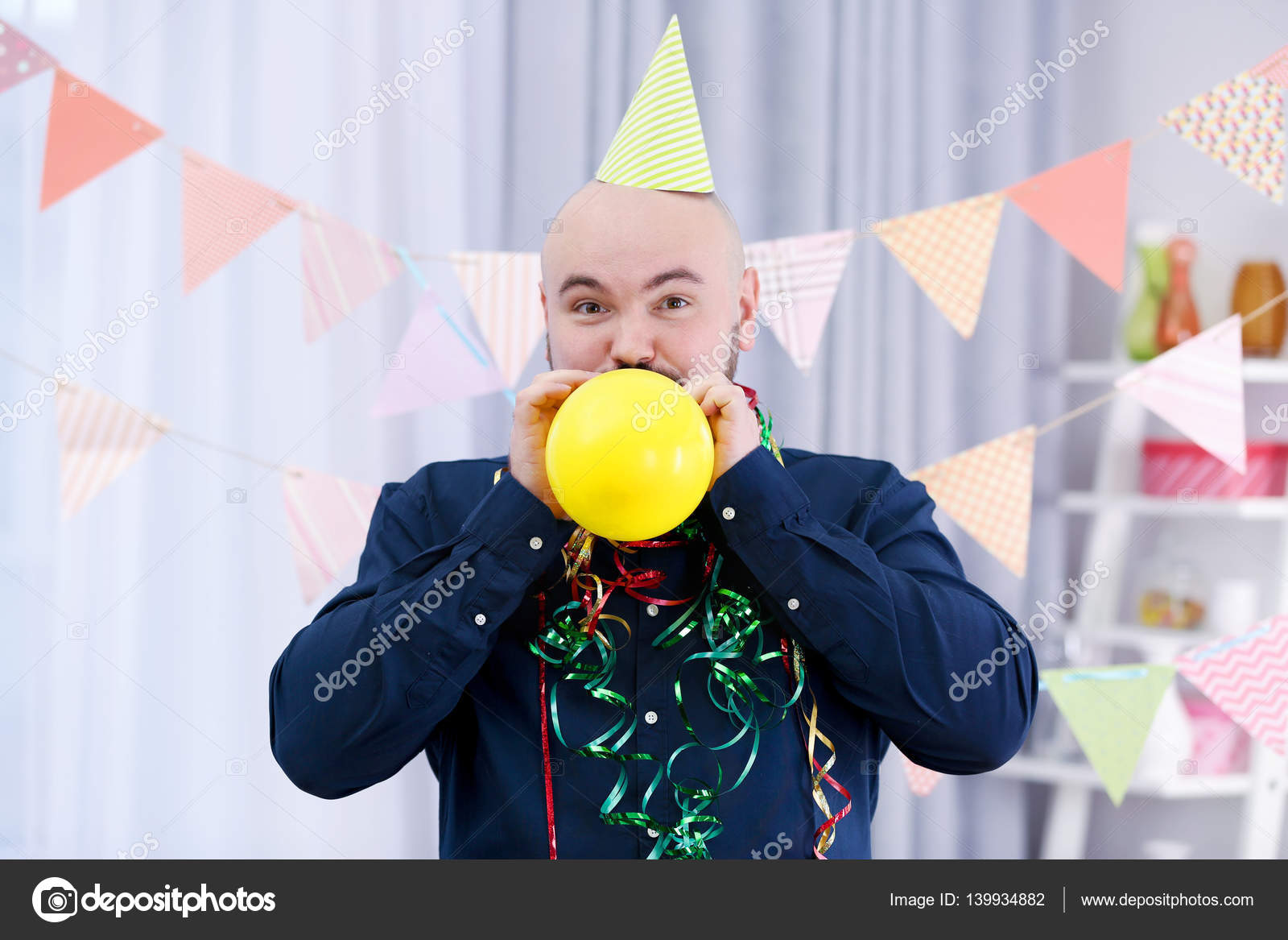 Funny fat man inflating balloon at birthday party Stock Photo by ...