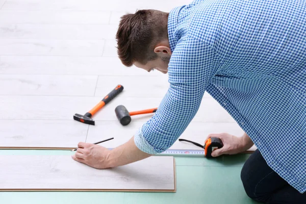 Man installing laminate flooring — Stock Photo © belchonock #146177221 Man installing laminate flooring — Stock Photo © belchonock #146177221
