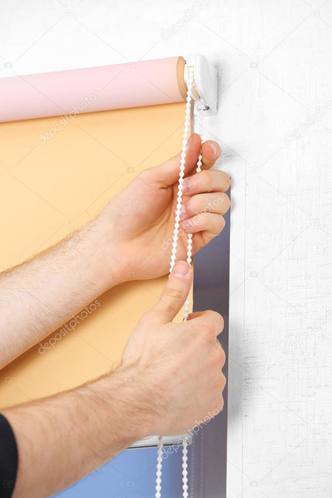 Hands installing roller blinds — Stock Photo © belchonock #146171877