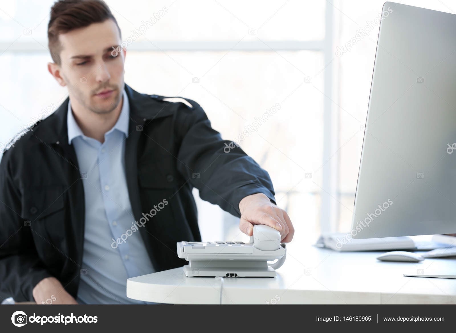 Handsome security guard using telephone in surveillance room Stock ...
