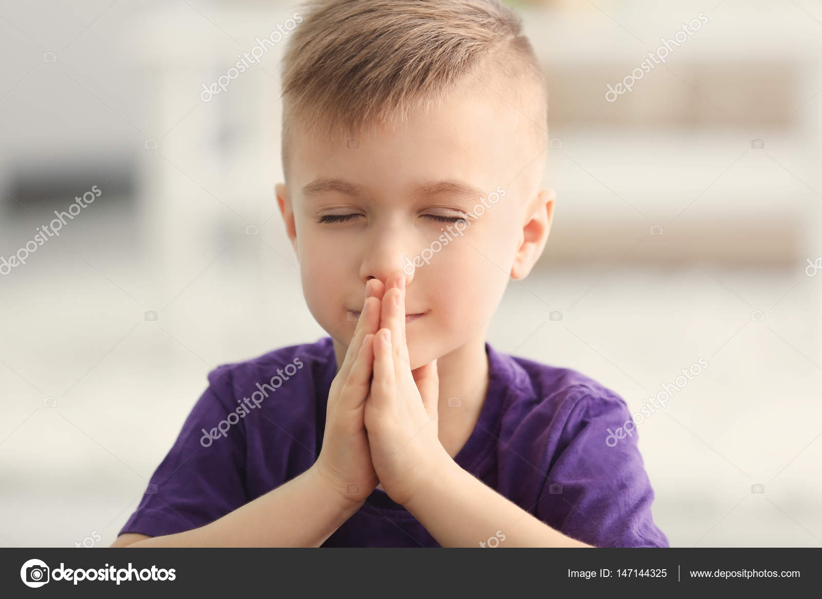 Little boy praying — Stock Photo © belchonock #147144325