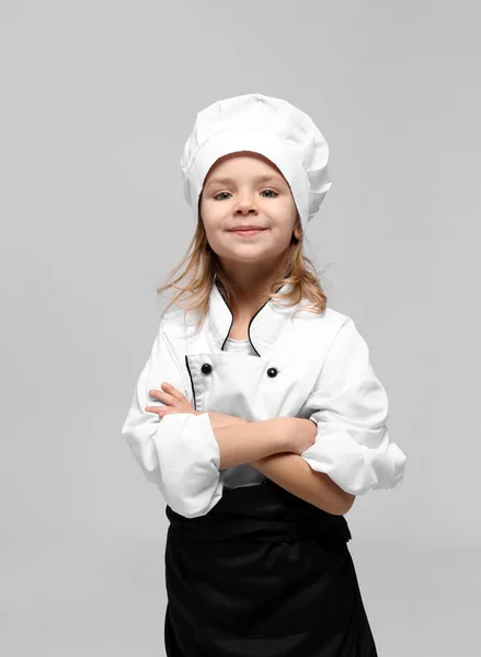 Cute girl in chef uniform Stock Photo by ©belchonock 147138973