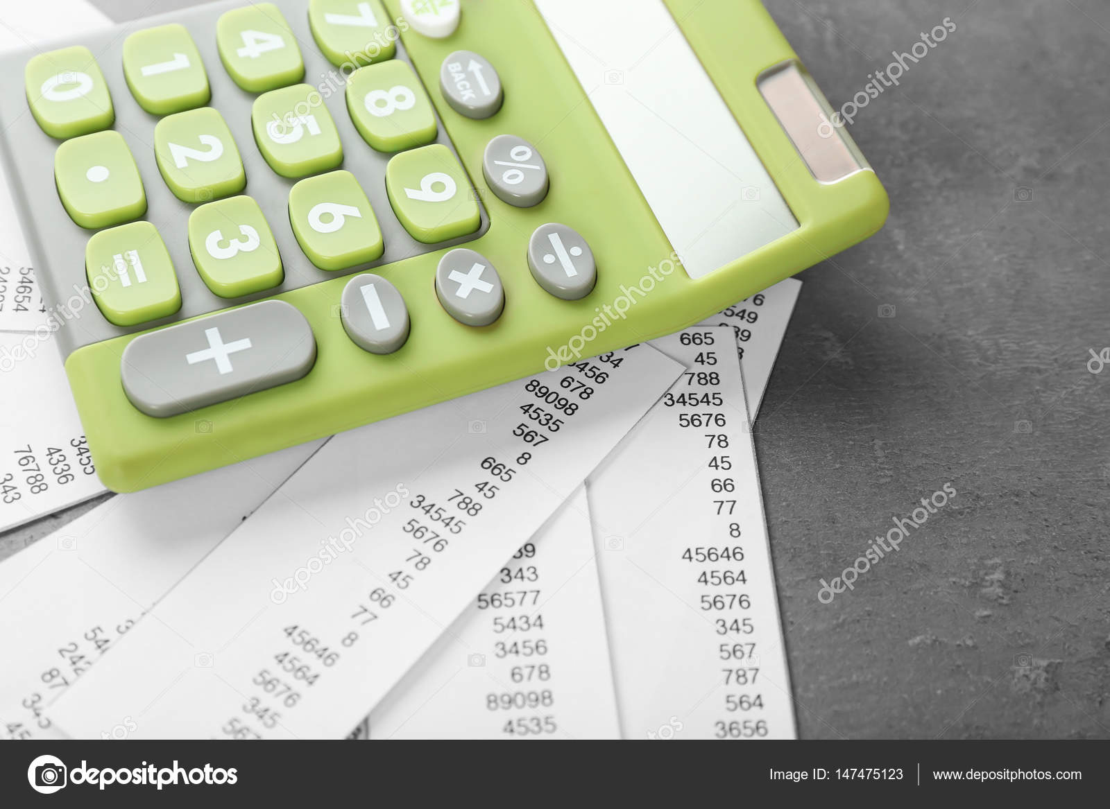 Green calculator and receipts Stock Photo by ©belchonock 147475123