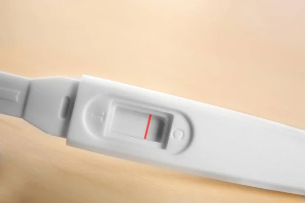 Pregnancy test on wooden table — Stock Photo © belchonock #147519769