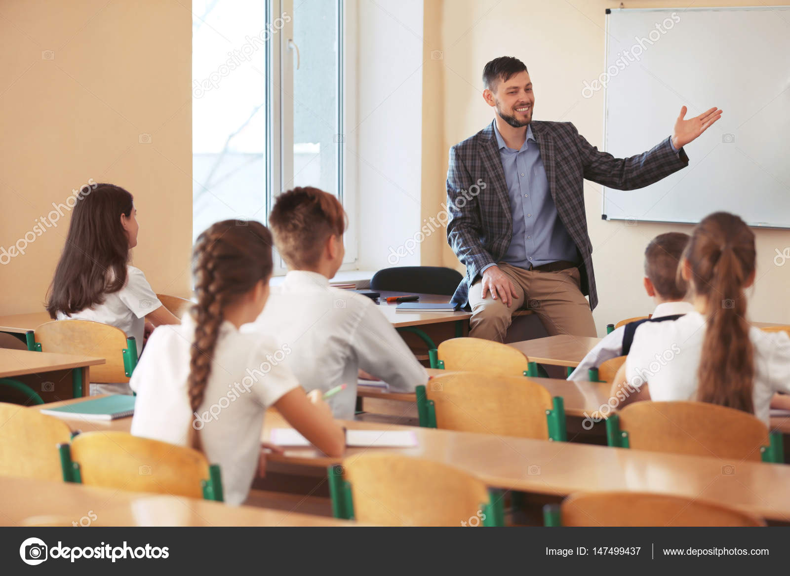 Pupils listening teacher in classroom Stock Photo by ©belchonock 147499437 Pupils listening teacher in classroom Stock Photo by ©belchonock 147499437
