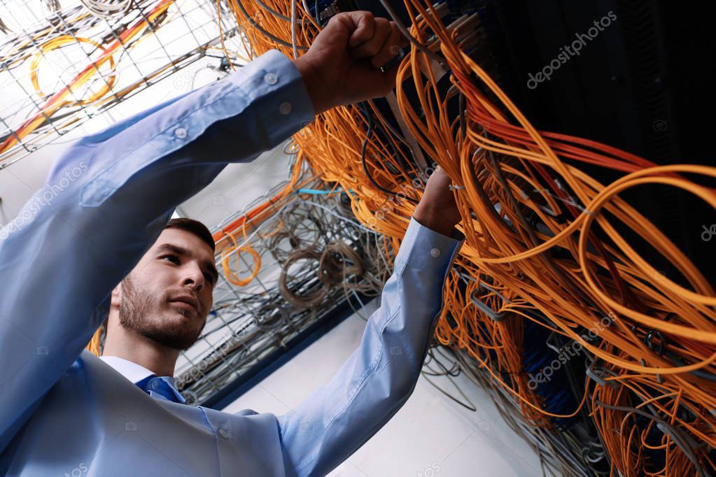 Ingeniero joven guapo conectando cables 2024