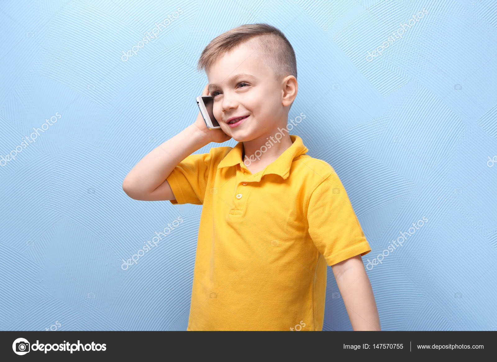 Cute little boy talking by phone Stock Photo by ©belchonock 147570755
