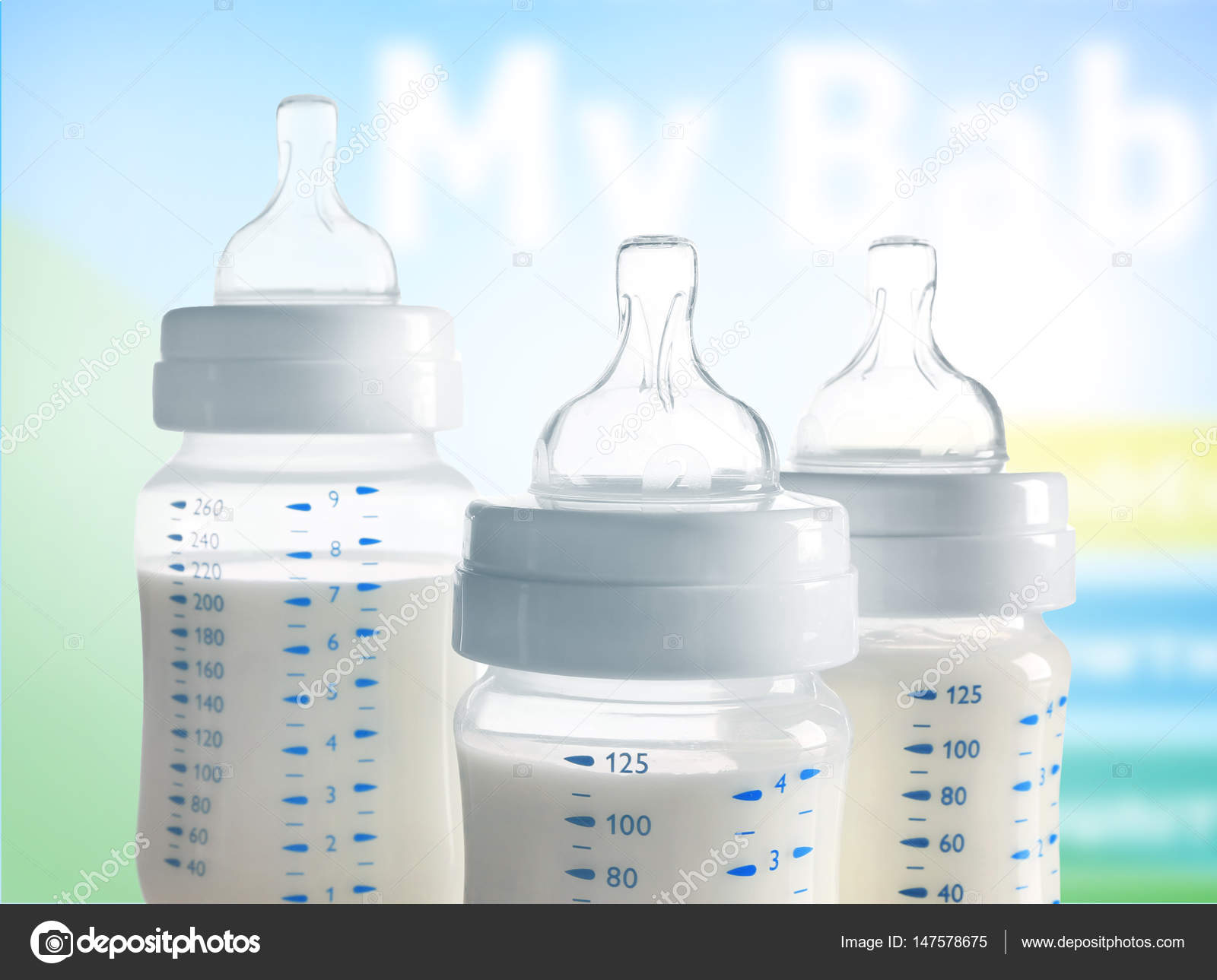 Feeding bottles with baby milk formula on blurred background — Stock ...