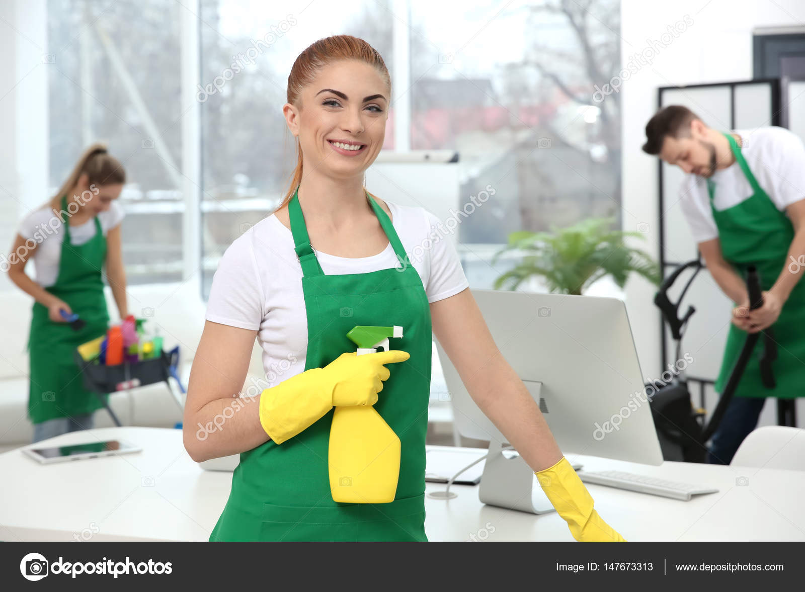 Young female cleaner at work in office Stock Photo by ©belchonock 147673313