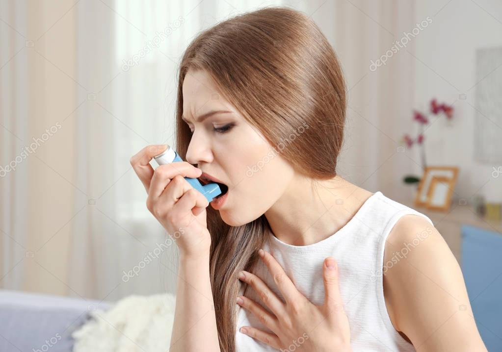 Woman using asthma inhaler — Stock Photo © belchonock #147826905