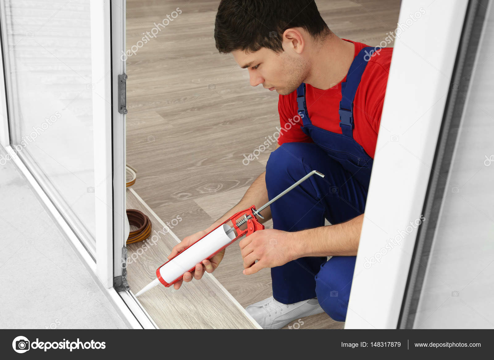 Worker sealing joints of office window — Stock Photo © belchonock ...