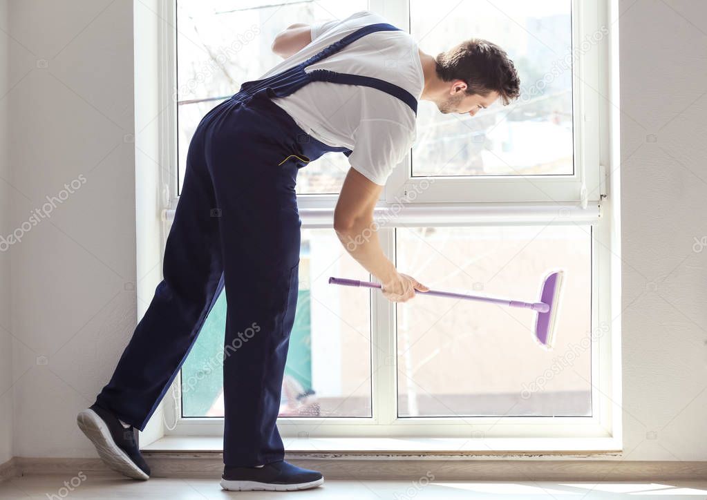 Man washing window in office — Stock Photo © belchonock #148797941