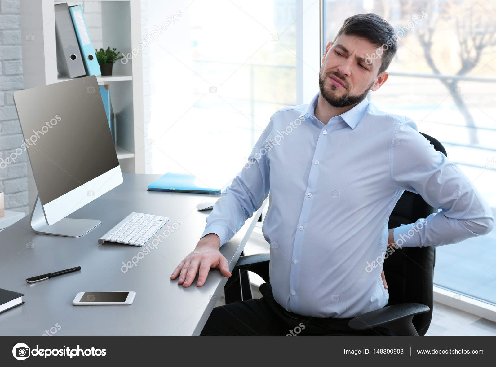 Man suffering from back pain — Stock Photo © belchonock #148800903