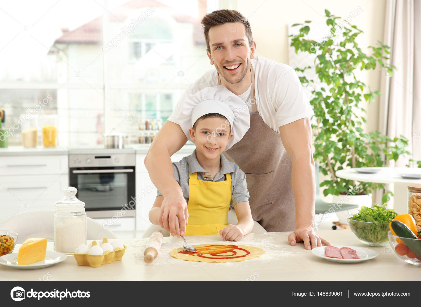 Dad and son cooking at home — Stock Photo © belchonock #148839061