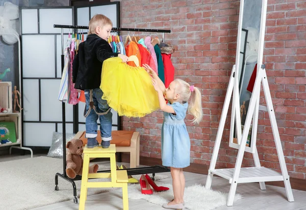 Children playing in dressing room Stock Photo by ©belchonock 150348036