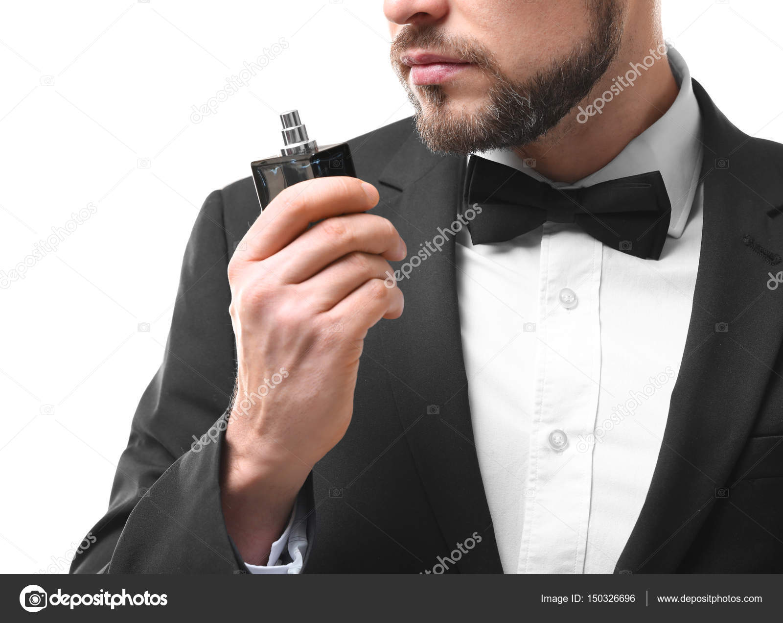 Handsome young man using perfume Stock Photo by ©belchonock 150326696