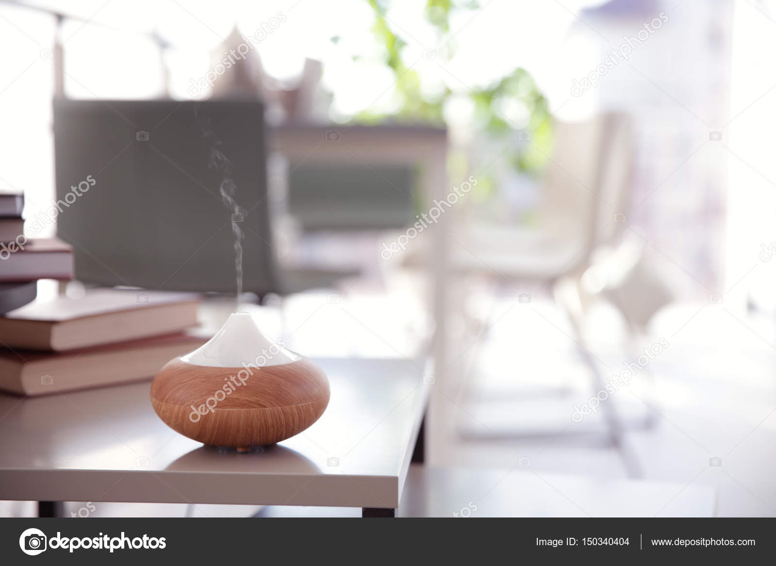 Electric oil diffuser at table — Stock Photo © belchonock #150340404