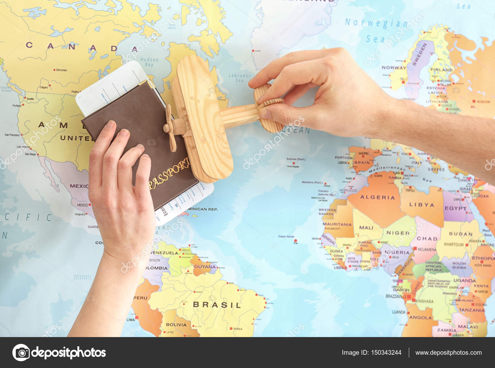 Hands of couple on map Stock Photo by ©belchonock 150343244
