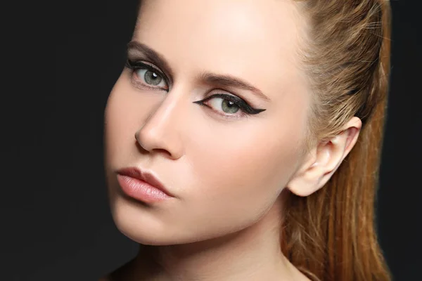 Beautiful young girl face on dark background Stock Photo by ©belchonock ...