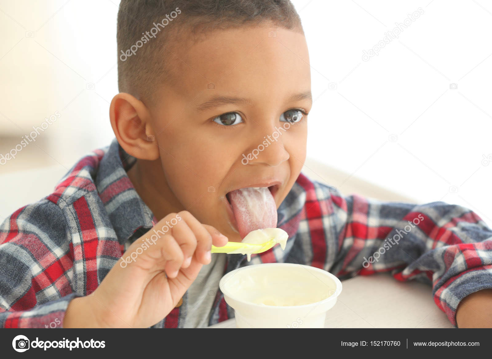 African boy drinking yogurt Stock Photo by ©belchonock 152170760