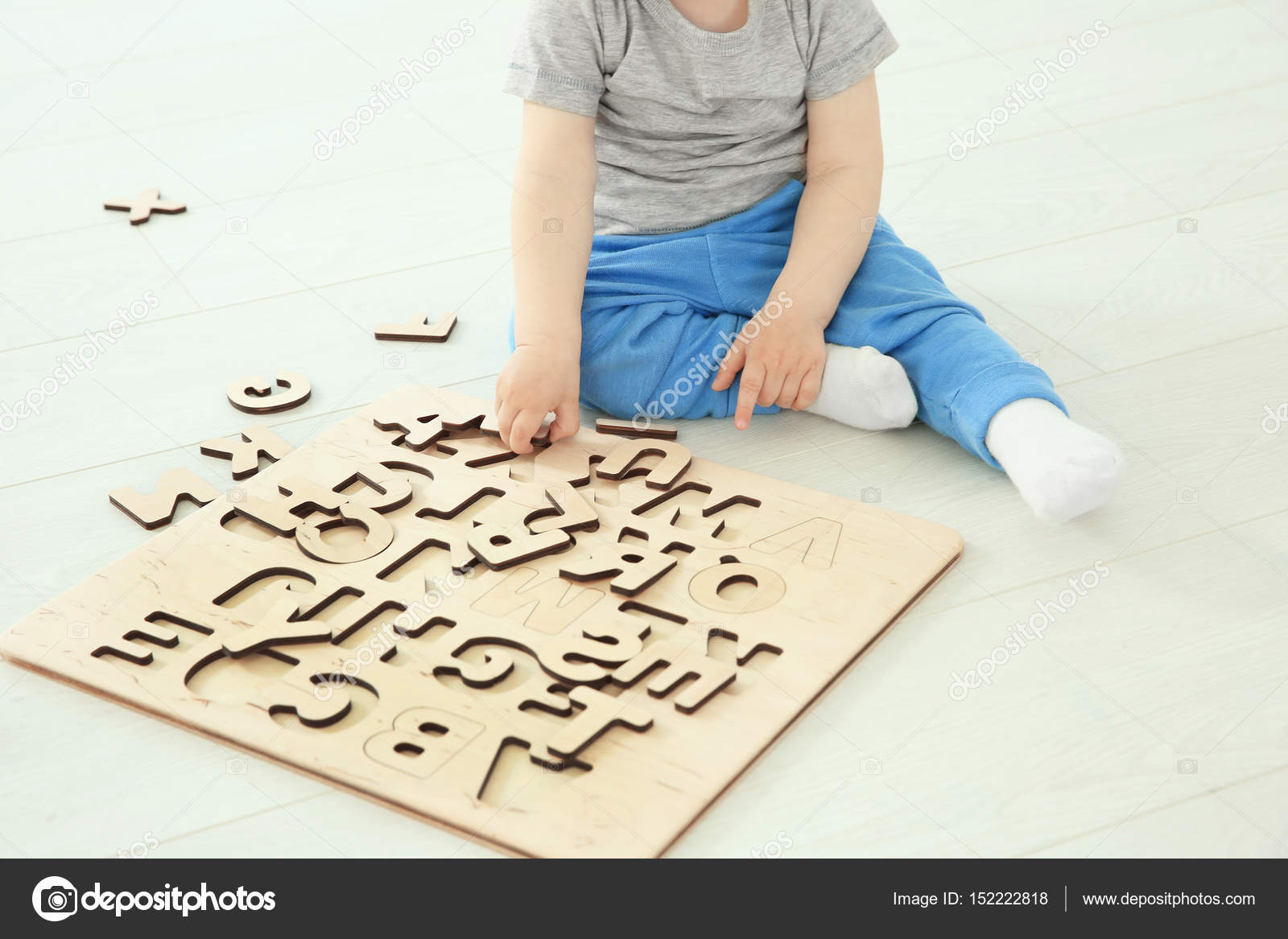 Child playing with letters — Stock Photo © belchonock #152222818
