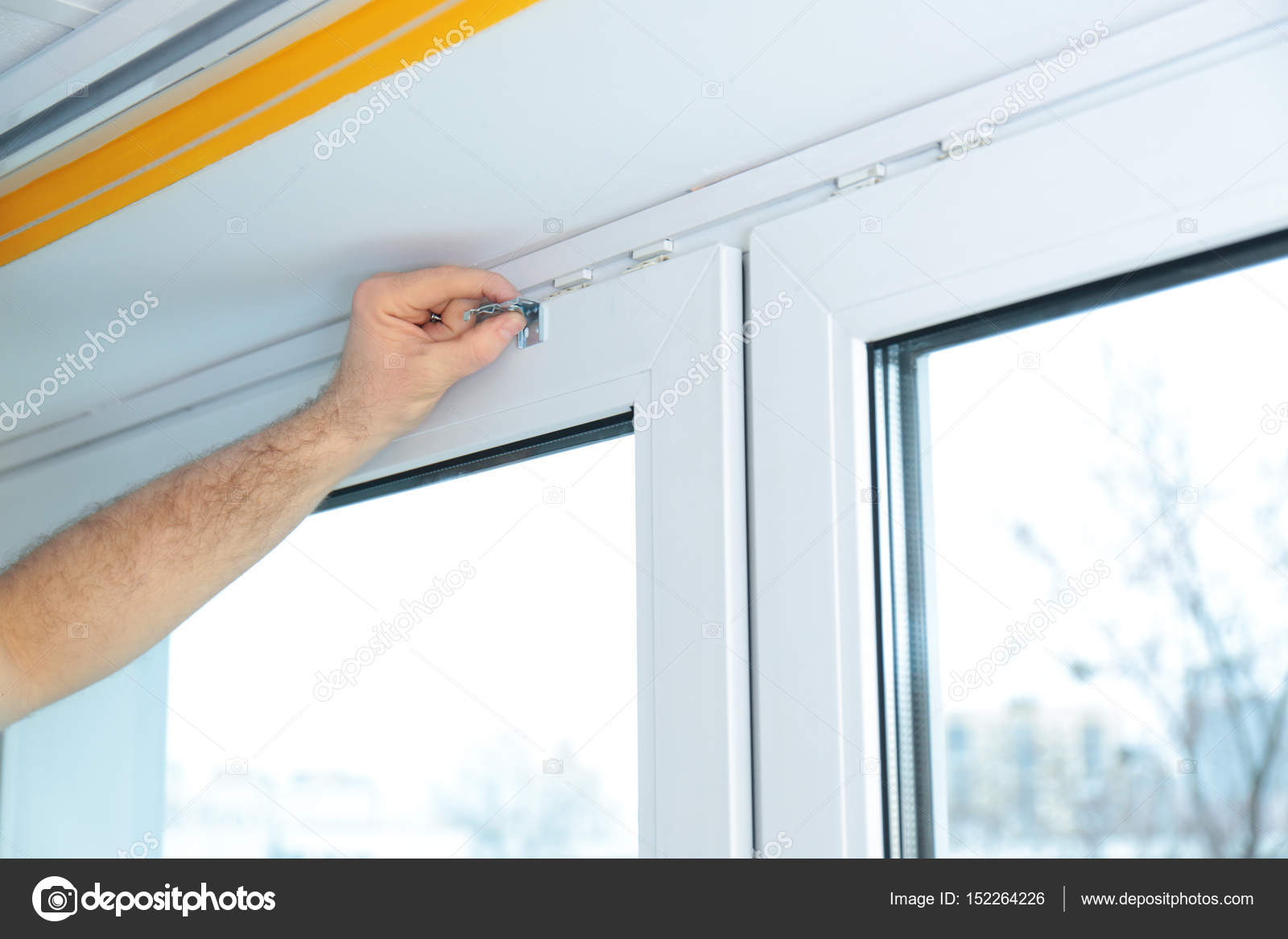 Man installing window blinds Stock Photo by ©belchonock 152264226