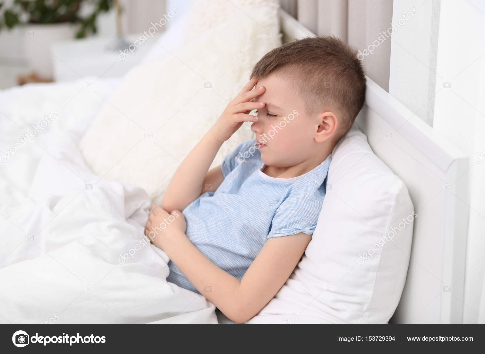 Little boy suffering from headache Stock Photo by ©belchonock 153729394