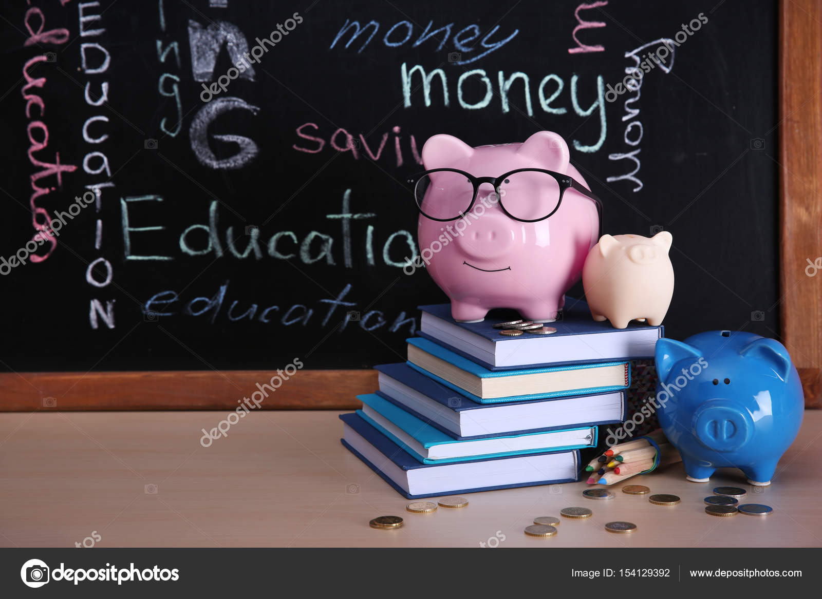 Three piggy banks with books and coins Stock Photo by ©belchonock 154129392