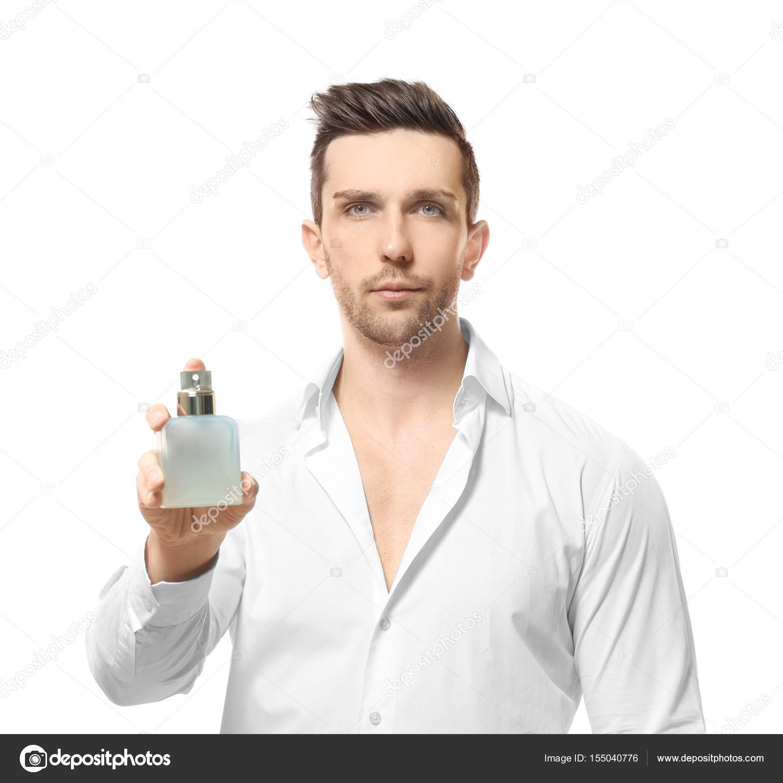 Handsome man using perfume Stock Photo by ©belchonock 155040776