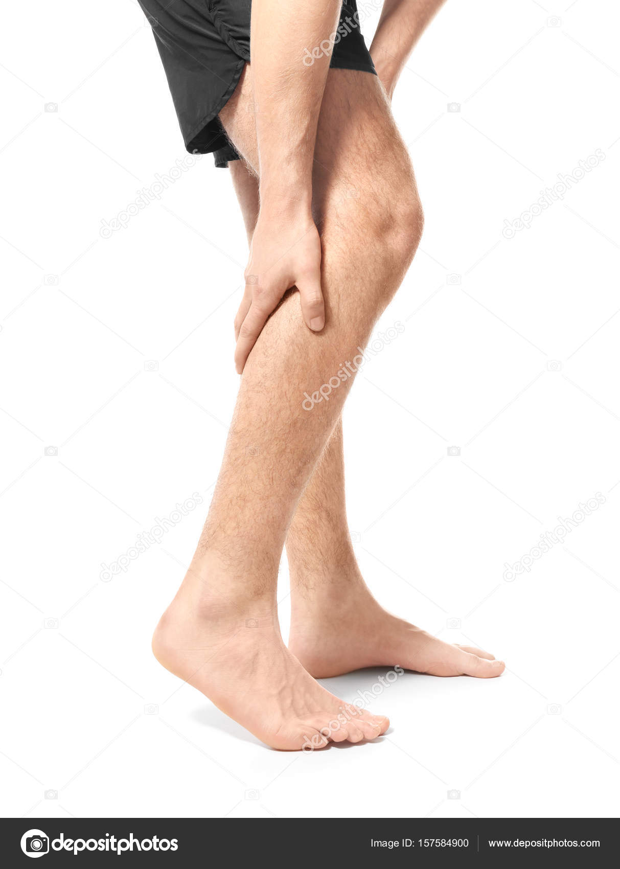Man suffering from pain in leg Stock Photo by ©belchonock 157584900
