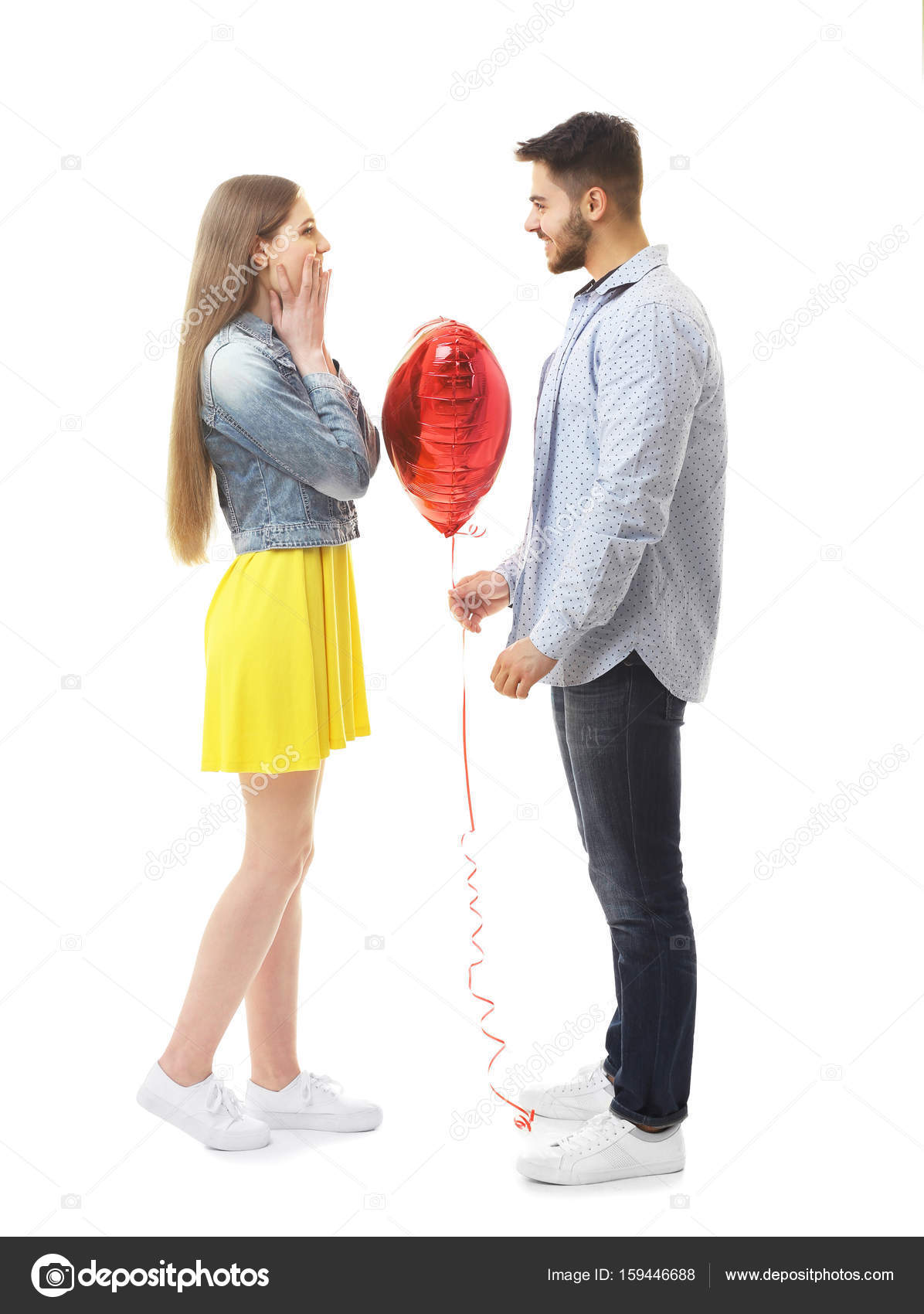 Young man giving balloon Stock Photo by ©belchonock 159446688