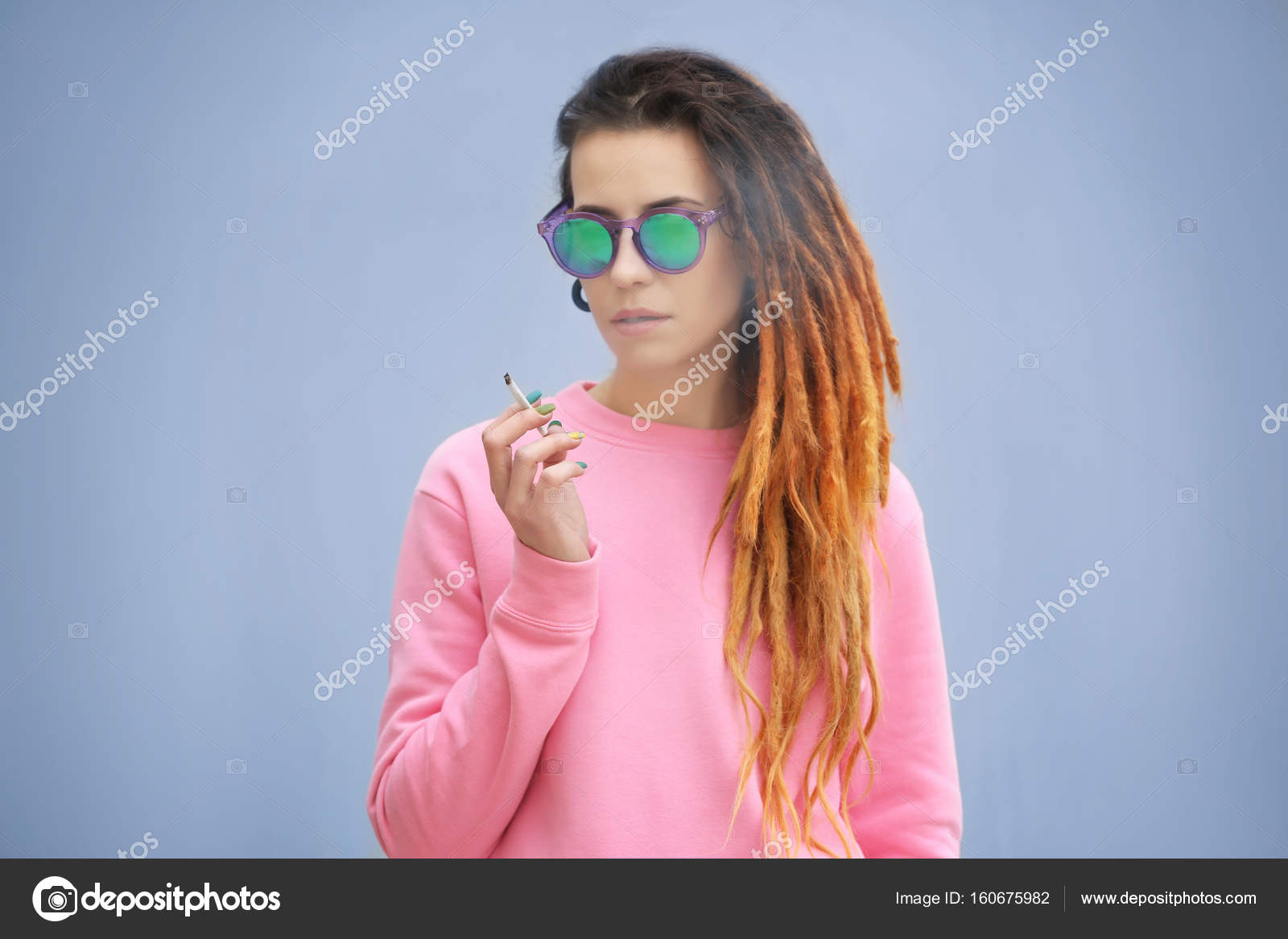 Young beautiful woman smoking weed Stock Photo by ©belchonock 160675982