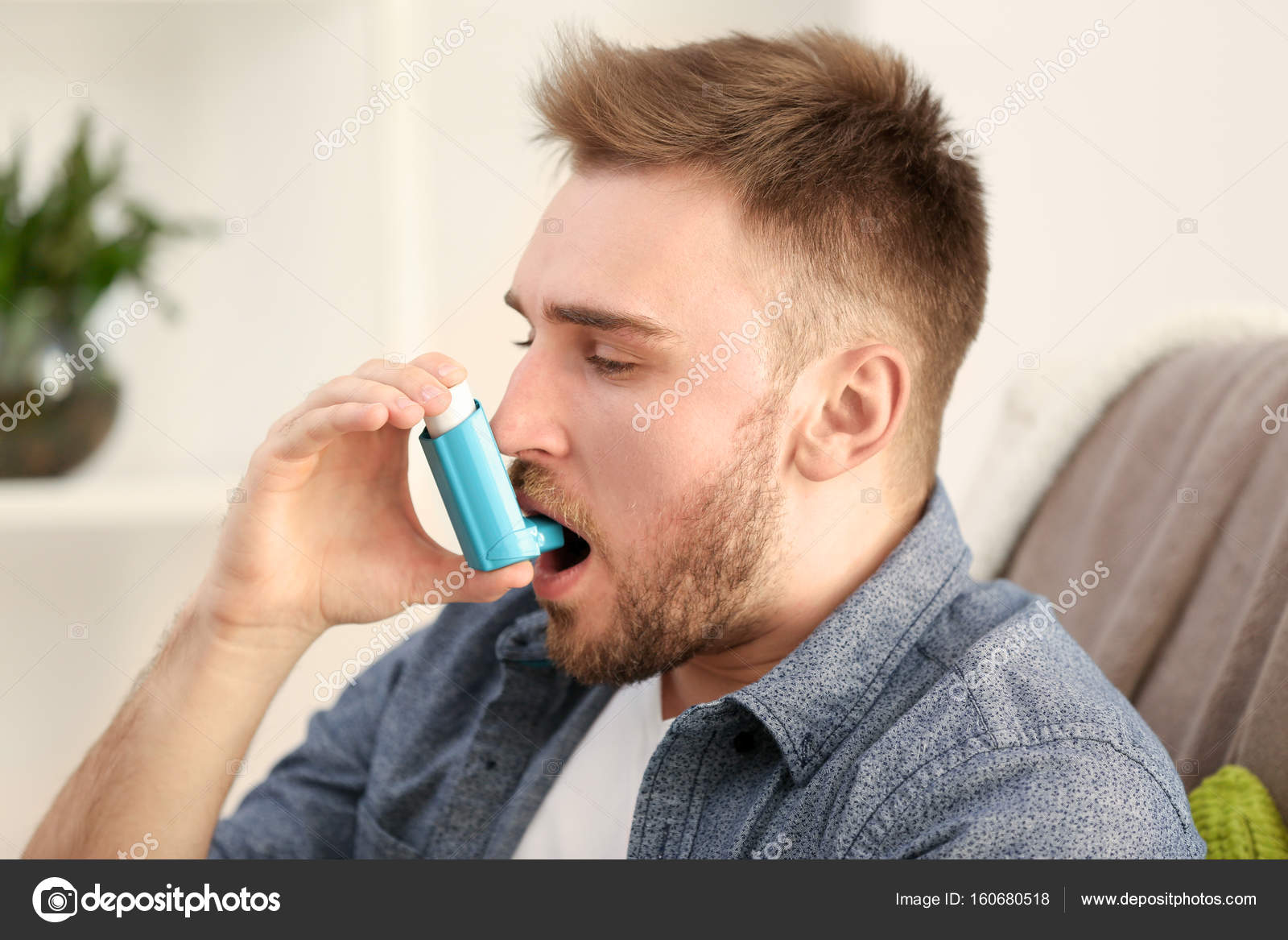 Young man using inhaler — Stock Photo © belchonock #160680518