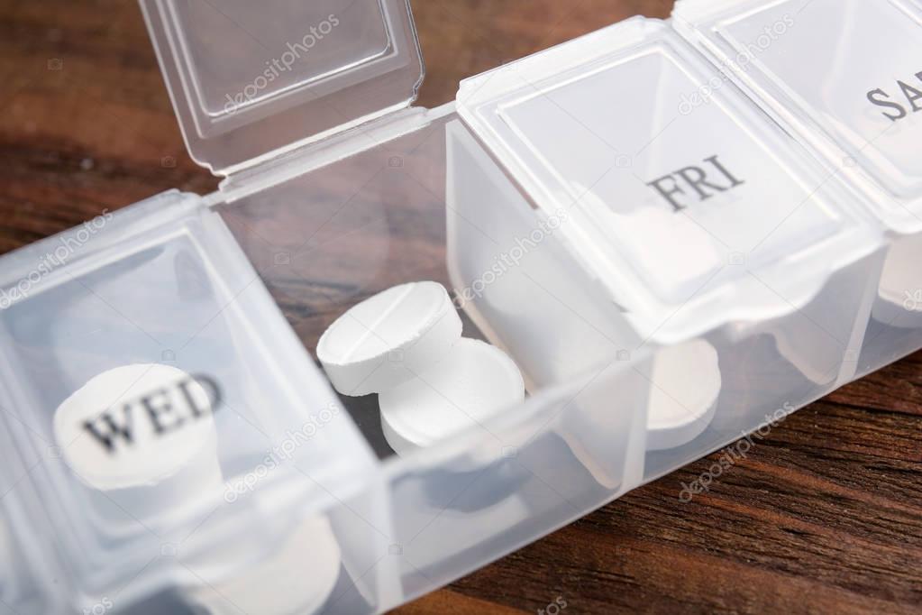 Plastic container with pills — Stock Photo © belchonock #162229612