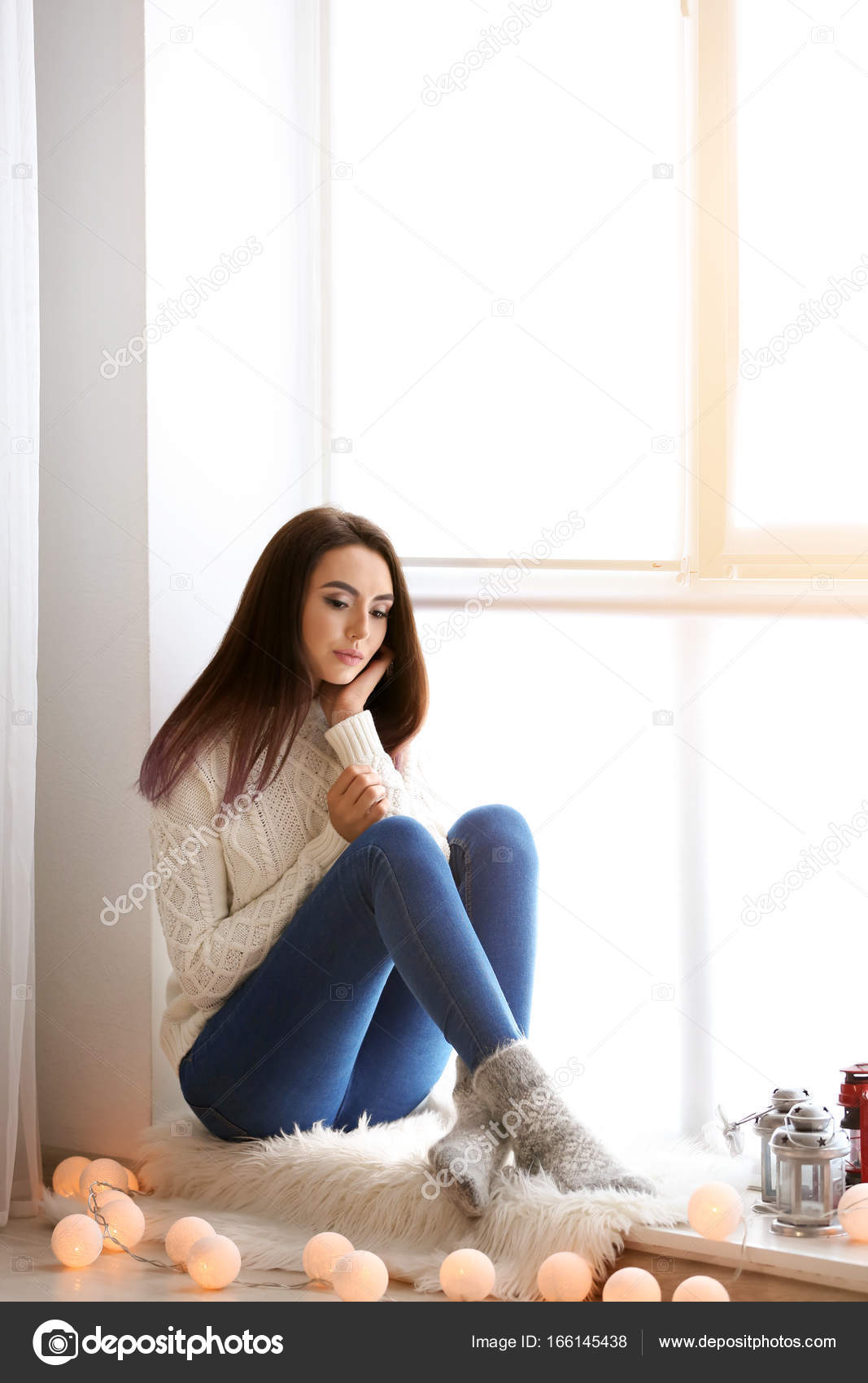 Lady sitting on window sill Stock Photo by ©belchonock 166145438