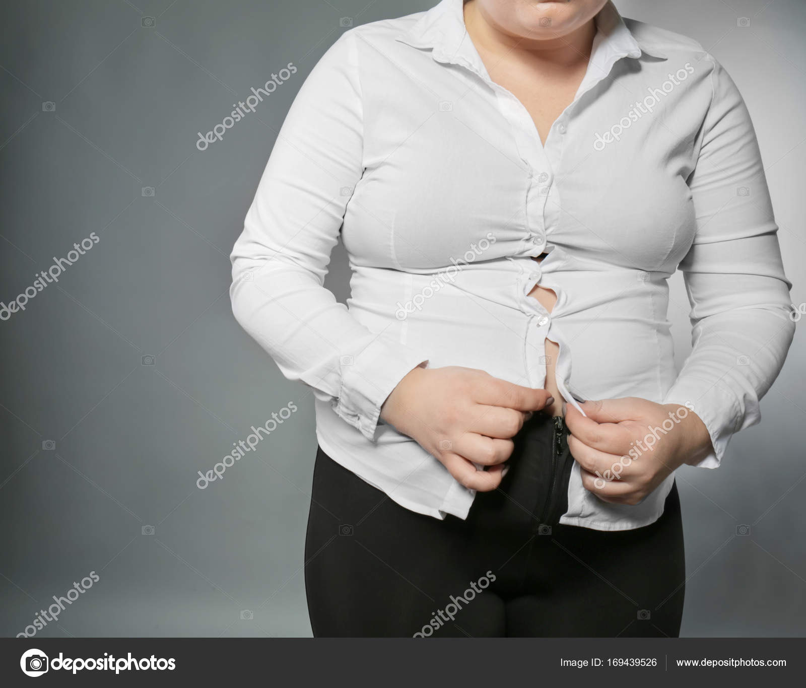 Overweight woman trying to button up shirt Stock Photo by ©belchonock ...