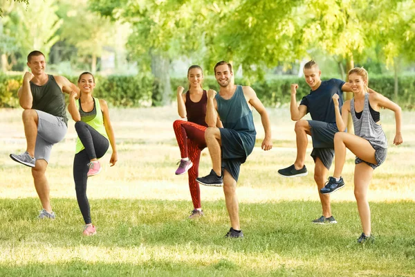 Group of friends or sportsmen exercising outdoors — Stock Photo © Syda ...