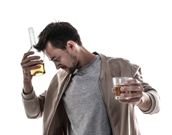 Drunk man with bottle and glass of whiskey on white background ...