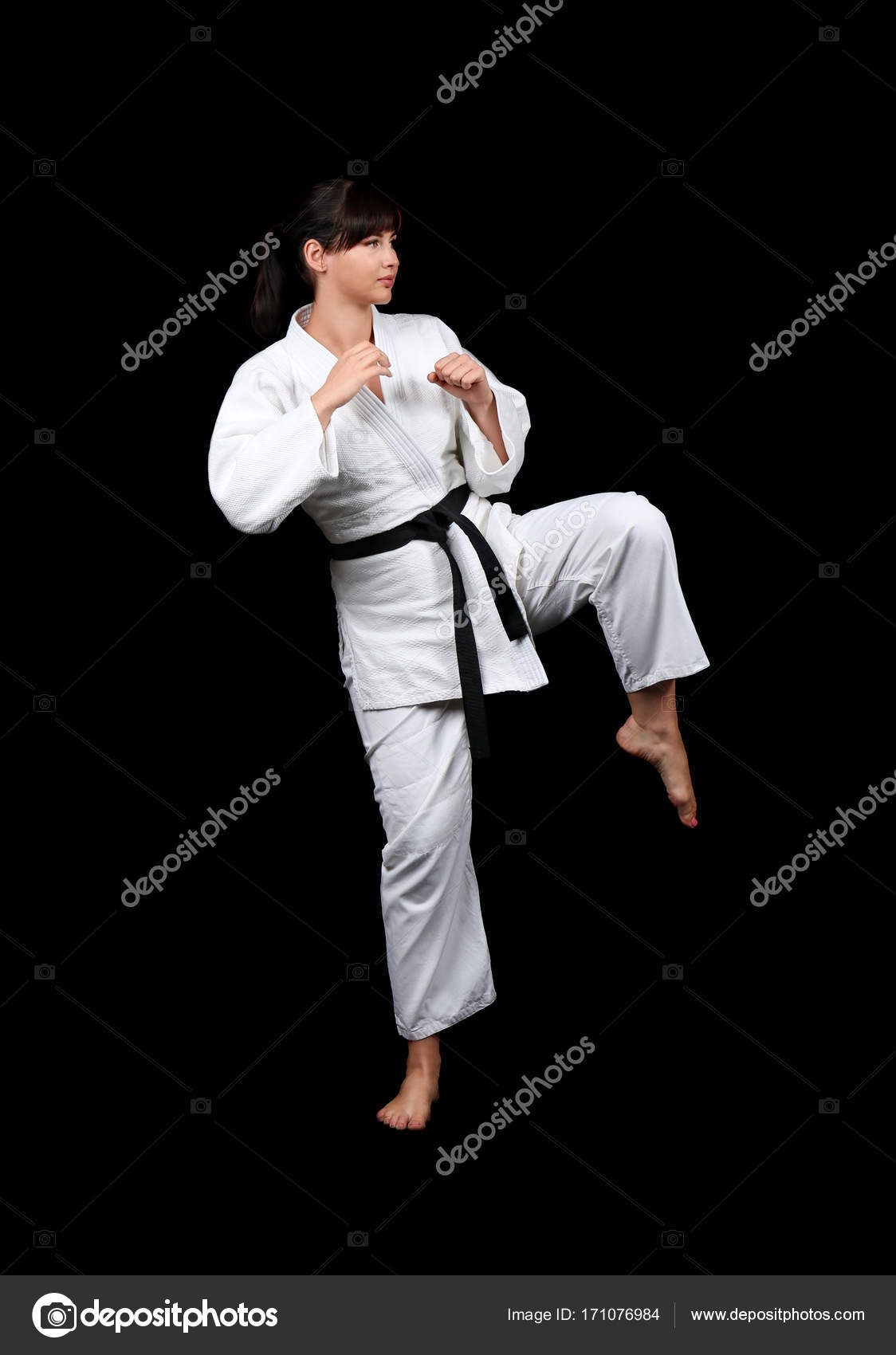 Young woman practicing karate Stock Photo by ©belchonock 171076984