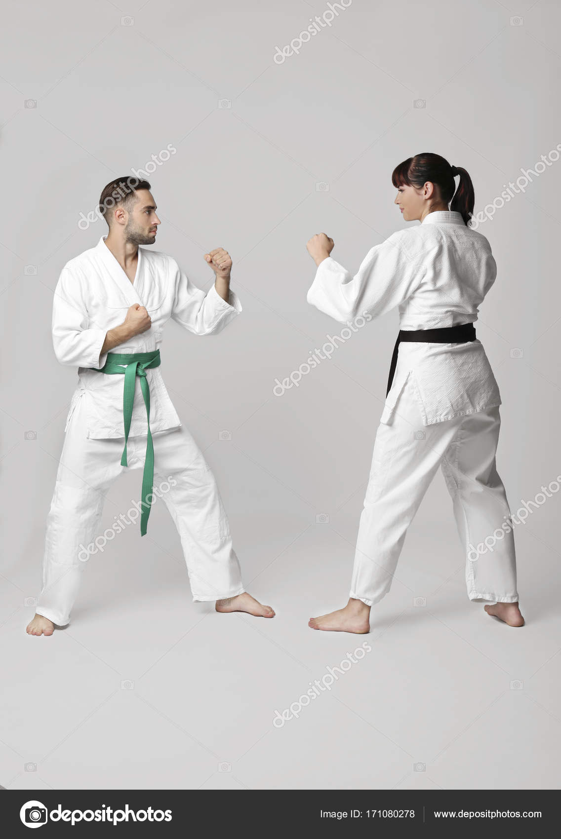 Man and woman practicing karate Stock Photo by ©belchonock 171080278