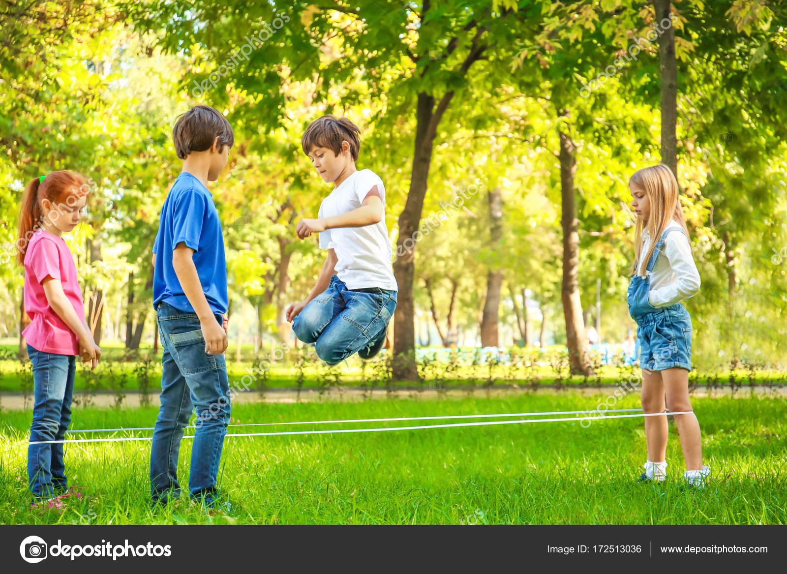 Cute little children jumping rope in park Stock Photo by ©belchonock ...