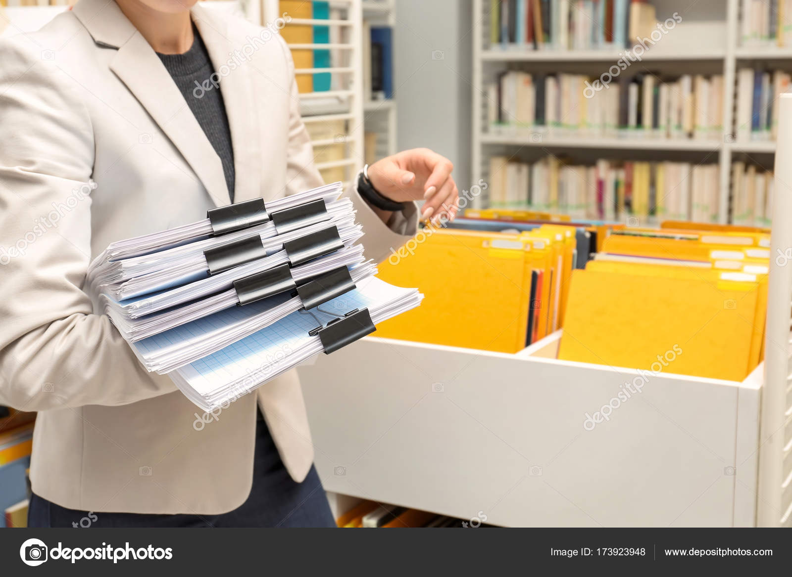 Woman searching for documents Stock Photo by ©belchonock 173923948