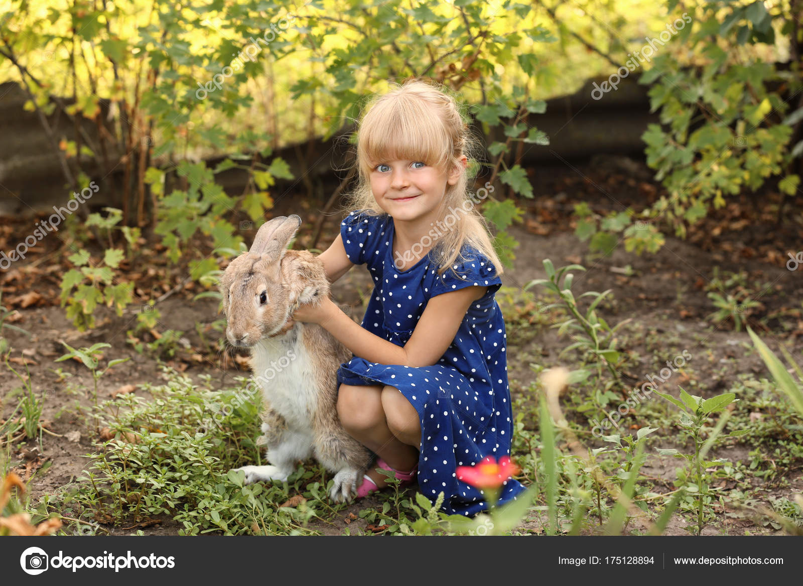 Little girl with adorable rabbit — Stock Photo © belchonock #175128894